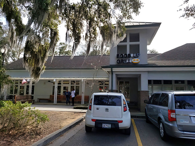 Spanish moss frames this breakfast haven like nature's own welcome sign. Pawleys Island's Eggs Up Grill promises morning magic beneath Carolina blue skies.