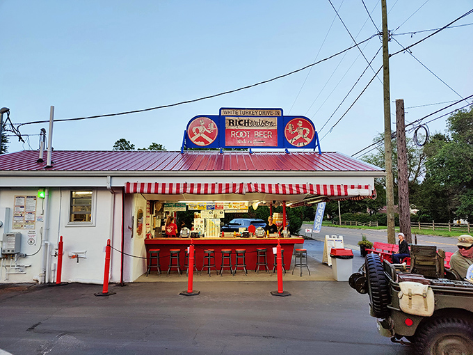 That red-striped awning and classic sign are like a beacon for hungry travelers. This little red-roofed time machine has been serving up nostalgia since Eisenhower was president.
