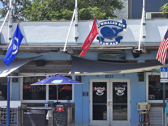 The unassuming blue-and-white exterior of The Whale's Rib stands like a salty sentinel, promising seafood treasures within. No pretense, just promise.