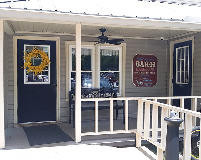 The unassuming front porch of Bar-H Barbecue proves once again that in Georgia, the most spectacular food often hides behind the most modest facades.