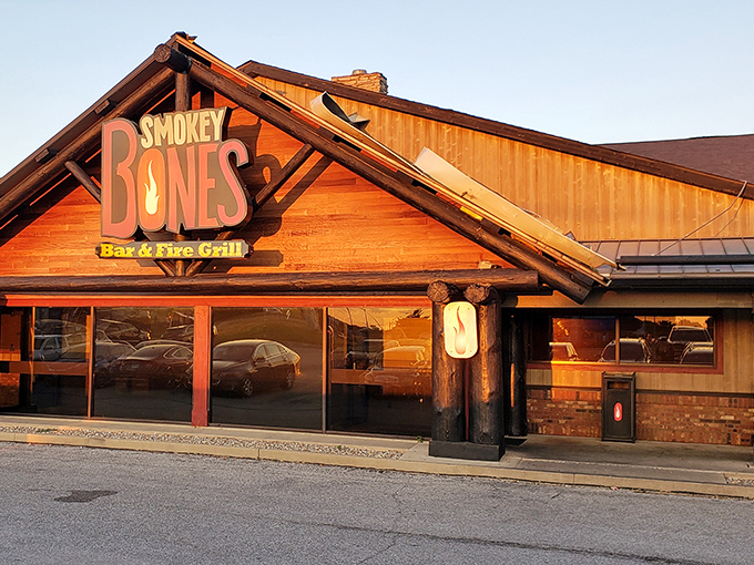 The rustic log cabin exterior beckons like a barbecue mirage in the prairie landscape. This isn't just a restaurant&mdash;it's a smoke signal to hungry travelers.