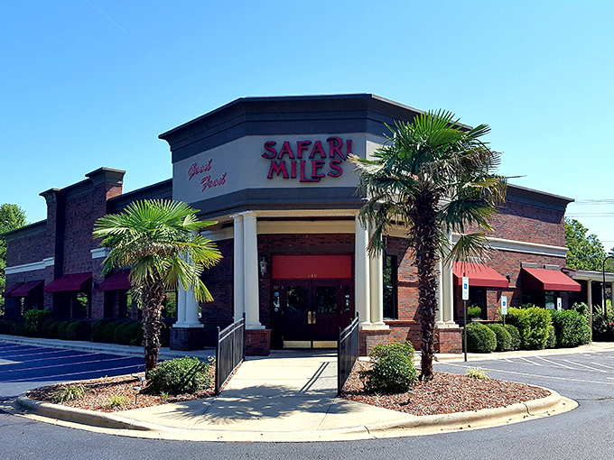 Palm trees in North Carolina? Safari Miles' tropical-meets-brick exterior creates an unexpected oasis that promises culinary adventure before you even step inside.