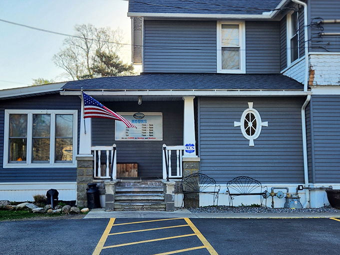 The nautical-inspired blue exterior of Jake's On Lake welcomes hungry travelers with its charming porch and American flag proudly waving in the Lake Erie breeze.