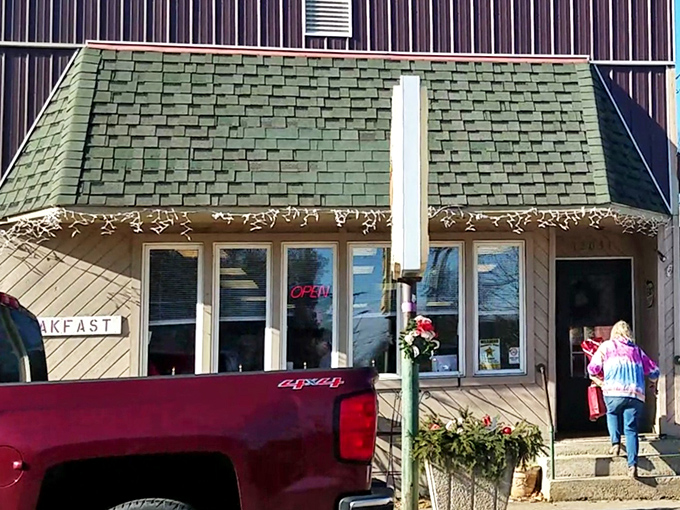 The green-shingled roof and cozy exterior of Hometown Hot Dogs beckons like an old friend waiting with open arms and sizzling grills.