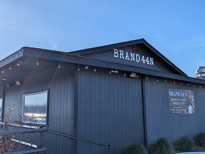 The unassuming black exterior of Brand 44&deg; N belies the breakfast treasures within. String lights hint at the warmth awaiting hungry travelers.