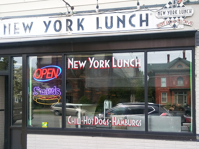 The unassuming storefront of New York Lunch belies the culinary treasures within. Classic neon signage promises simple pleasures done right.