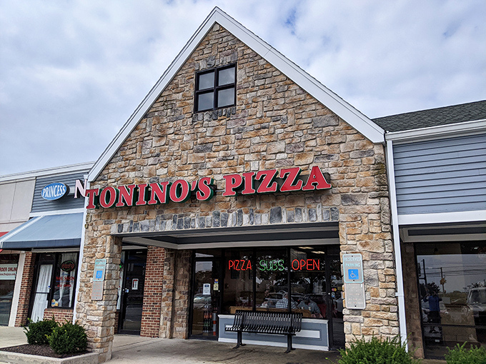 The stone facade of Tonino's Pizza glows with promise, like a beacon of comfort food calling you home after a long day.