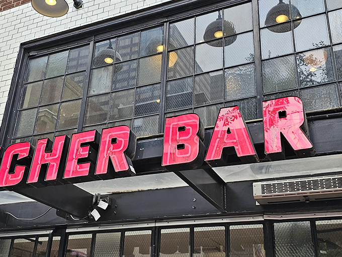 That iconic neon sign beckons like a carnivorous lighthouse. Butcher Bar's exterior promises meaty delights while hiding seafood treasures within.