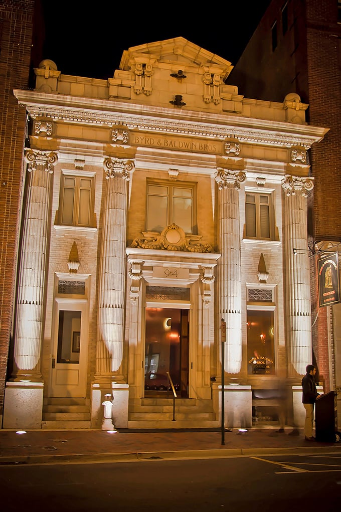 The grand neoclassical fa&ccedil;ade of Byrd & Baldwin Bros Steakhouse glows like a culinary temple at night, beckoning hungry pilgrims with promises of carnivorous delights.