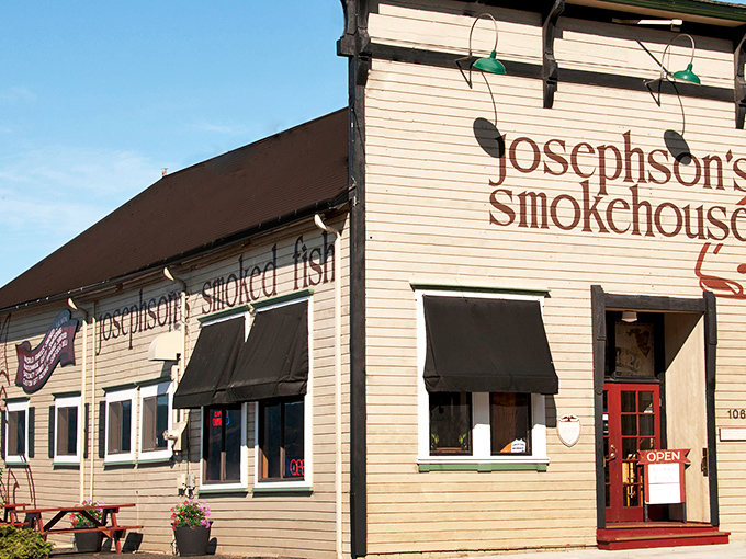 The unassuming beige building with black awnings stands like a sentinel of smoke and seafood, promising treasures that have lured Oregonians to Astoria for generations.