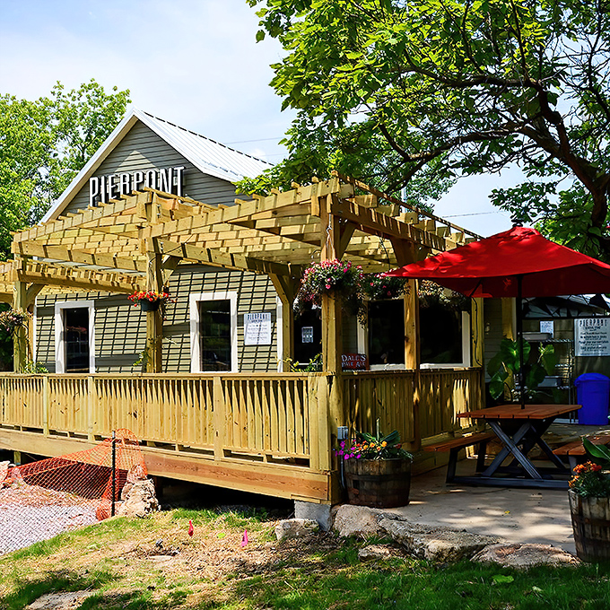 The wooden pergola and hanging flower baskets aren't trying to impress anyone&mdash;they're just being their authentic, charming Missouri self. Pure roadside magic.