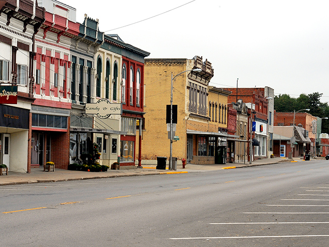 Rock Port's historic Main Street showcases classic Americana with its colorful facades and vintage storefronts. Watts Cleaners stands as a testament to businesses that have served generations.