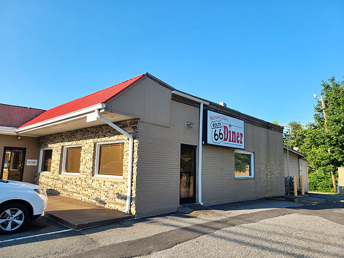 The iconic red roof and stone facade of Route 66 Diner beckons hungry travelers like a roadside oasis in Kernersville.