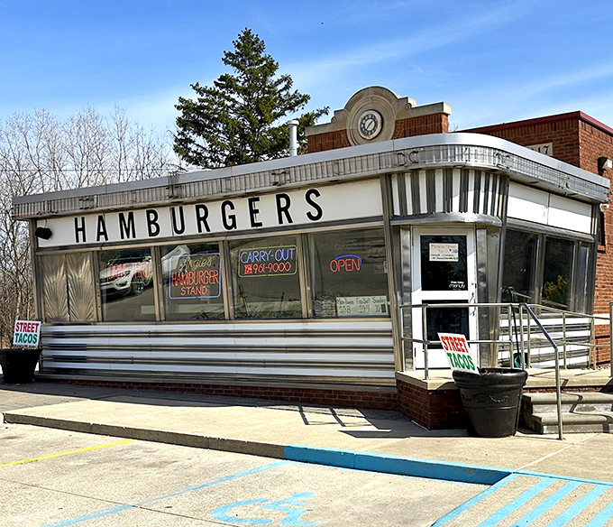 The gleaming silver exterior of Angie's Hamburger Stand stands like a time capsule from the golden age of roadside diners, promising simple pleasures done right.