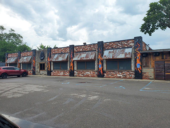 The rustic exterior of Bad Brad's BBQ beckons like a smoke signal to hungry travelers. Wood stacks and stone accents promise authentic barbecue magic within.