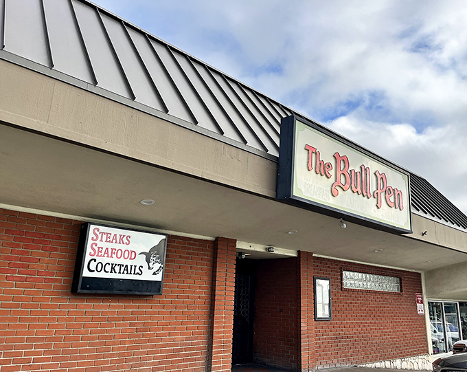 The unassuming exterior of The Bull Pen speaks volumes: great steakhouses don't need flashy facades when the meat inside does all the talking.