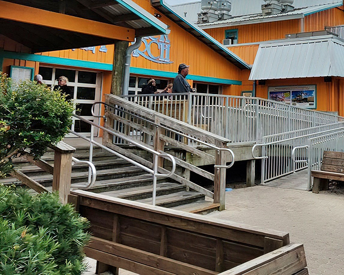 The iconic wooden exterior of The Back Porch, with its distinctive blue signage, promises seafood treasures within. Florida coastal dining at its unpretentious best.