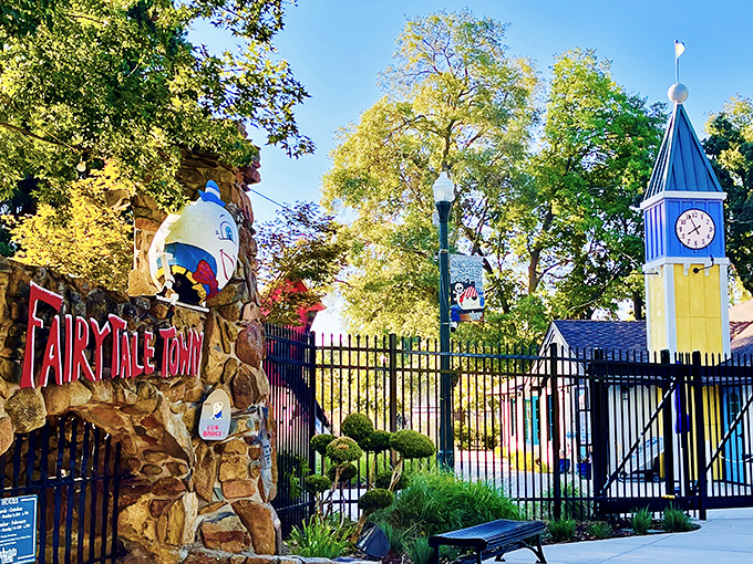 The iconic entrance to Fairytale Town beckons with its whimsical clock tower and Humpty Dumpty perched precariously atop the stone wall. 