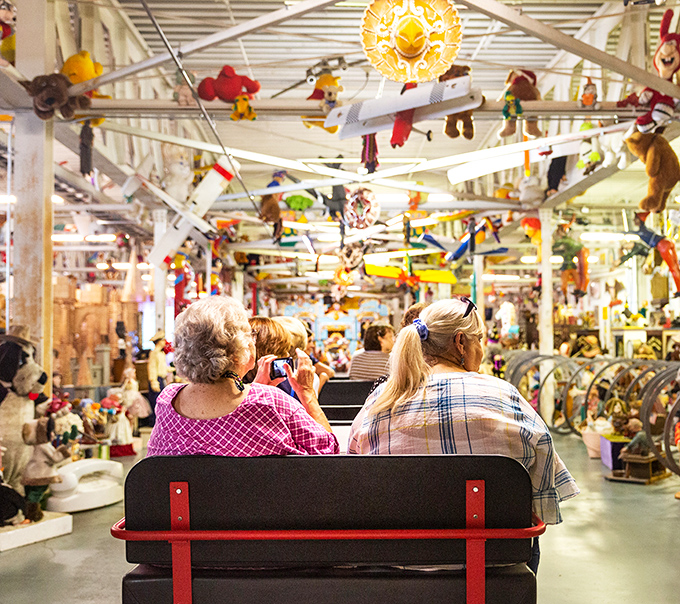 Riding through a wonderland of suspended stuffed animals and vintage treasures. The tram tour at American Treasure Tour Museum is sensory overload in the best possible way.