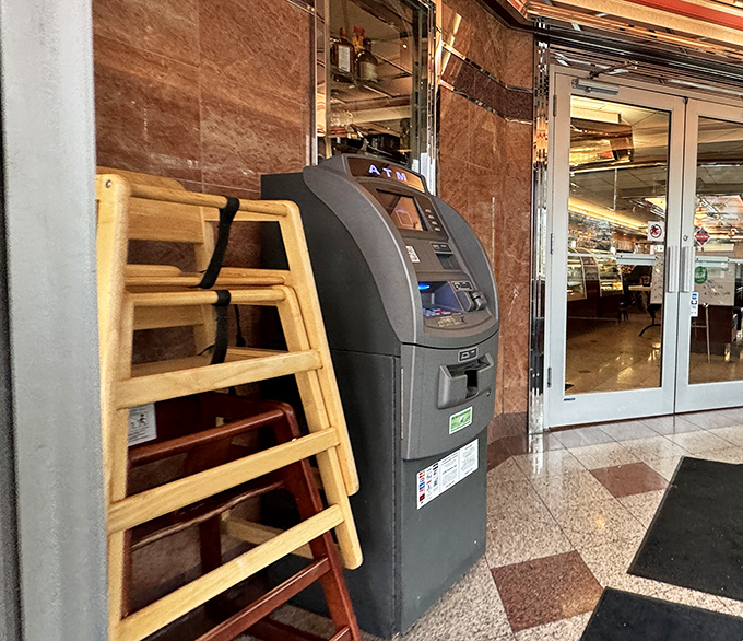 Even the ATM looks like it belongs in this timeless setting, standing ready for those "cash only" moments that define authentic diners.
