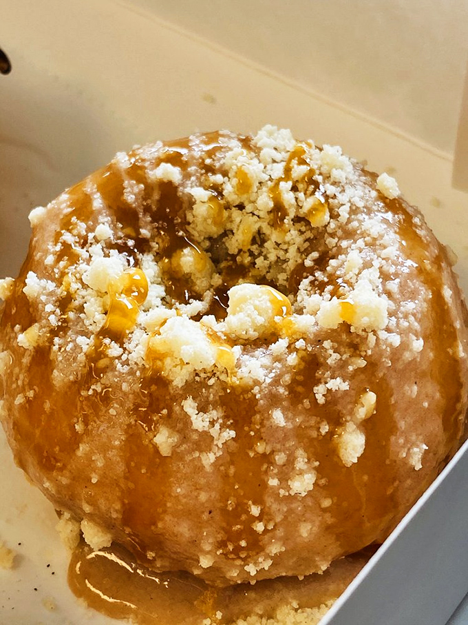 This caramel-drizzled creation with its crown of buttery crumbs isn't just a donut &ndash; it's what autumn would taste like if seasons were edible.
