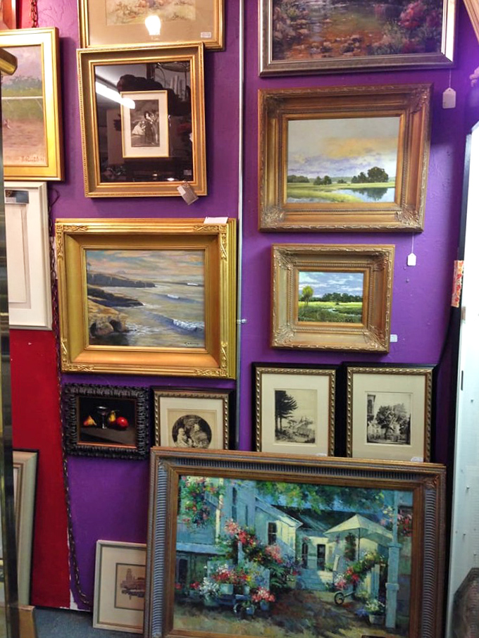 The purple gallery wall creates a royal backdrop for landscapes and seascapes that capture Florida's natural beauty through artists' eyes.