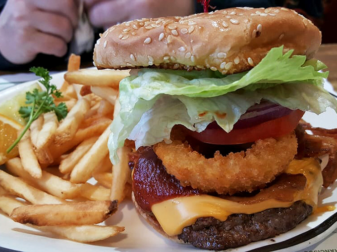 This isn't just a burger, it's architectural genius&mdash;stacked high with an onion ring, bacon, and cheese that melts into every delicious crevice.