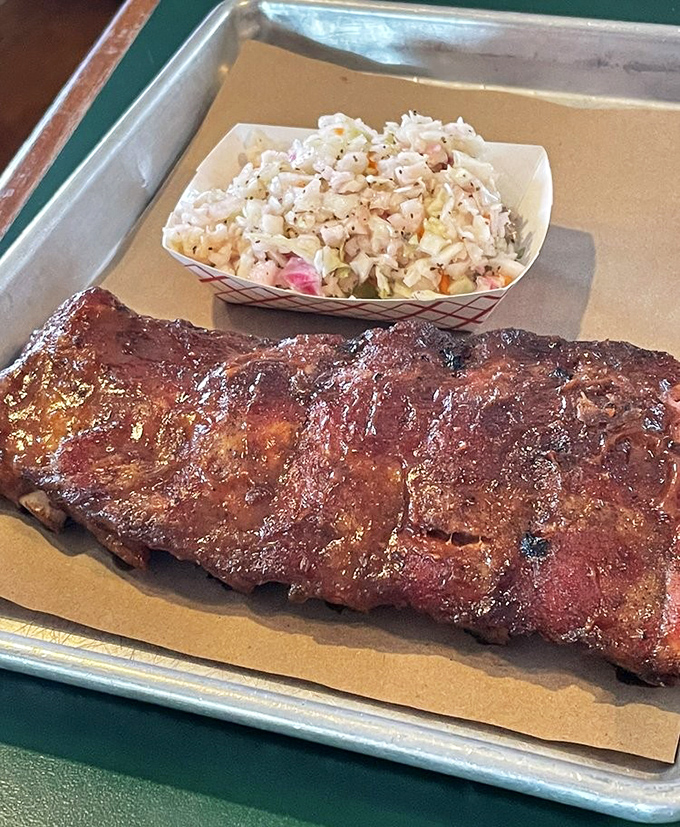 Baby back ribs with a smoke ring so perfect it could be used to propose marriage, paired with coleslaw that cuts through the richness.
