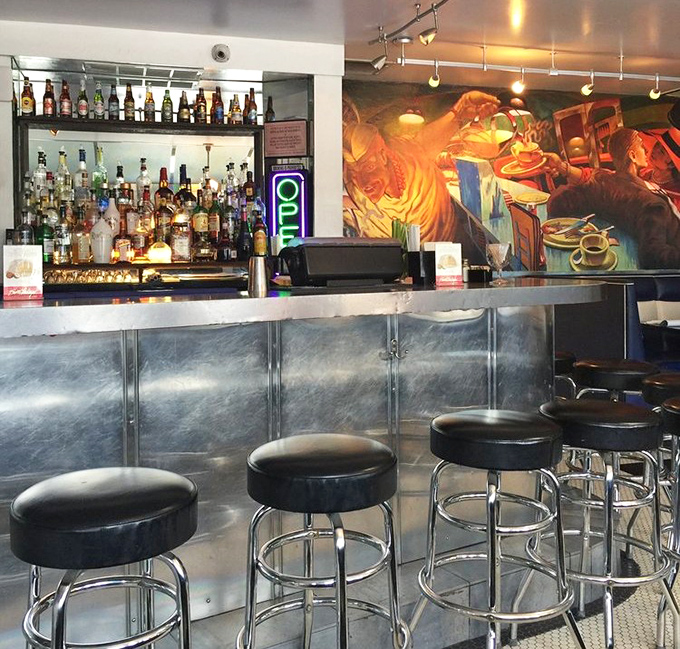 The bar area &ndash; where Art Deco meets liquid therapy with a mural that seems to say, "Stay awhile, the stories get better."