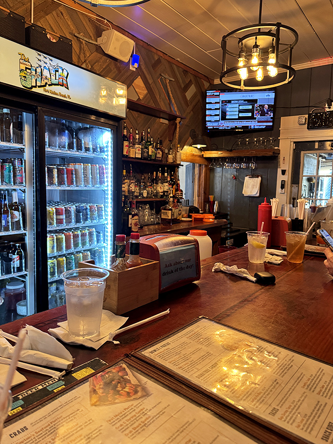 The bar at The Shack&mdash;where cold drinks and warm conversation flow as freely as the nearby Gulf waters.