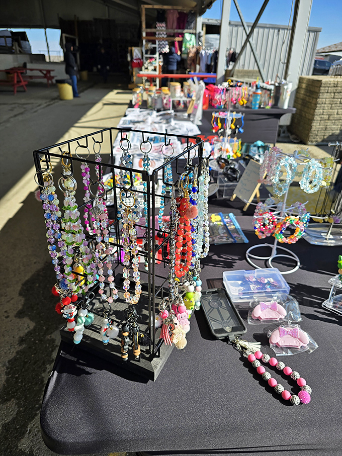 Jewelry dangles like colorful wind chimes, each beaded creation catching light and attention from passersby hunting for the perfect accessory.
