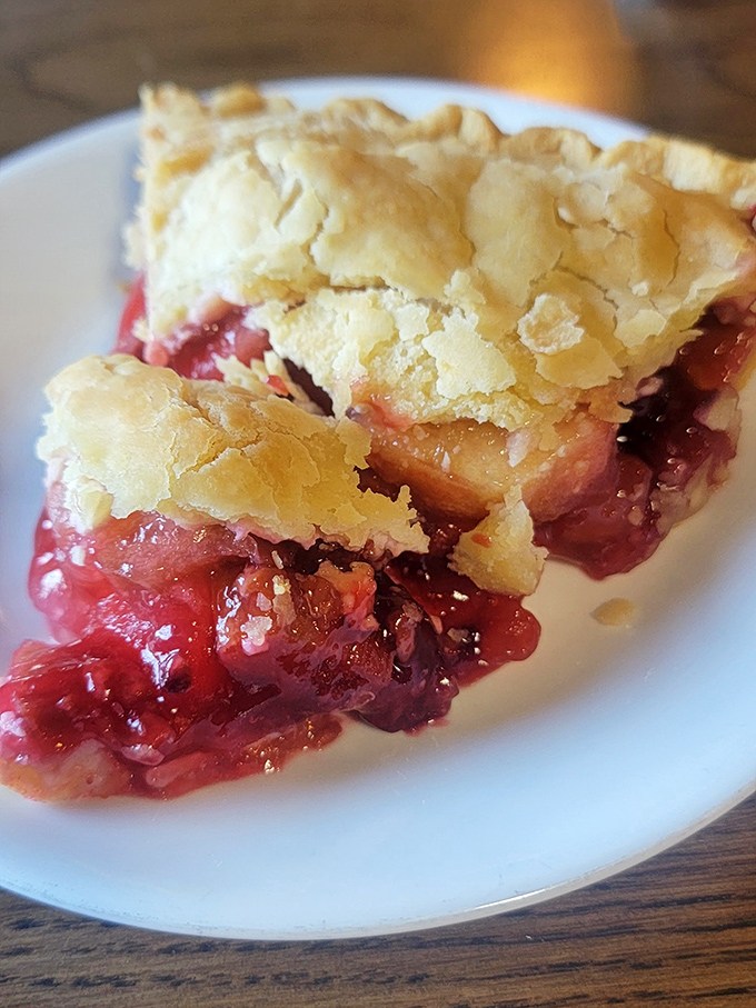 Berry pie that makes you understand why people used to cool these on windowsills. The flaky crust barely containing its sweet, ruby-red filling.