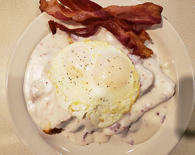 Biscuits and gravy with a sunny-side-up egg that's basically winking at you, saying "Yes, this is exactly what you need."