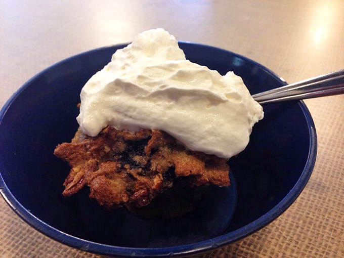 The bread pudding topped with whipped cream offers a sophisticated take on a homestyle favorite &ndash; the perfect sweet finale to a savory feast.
