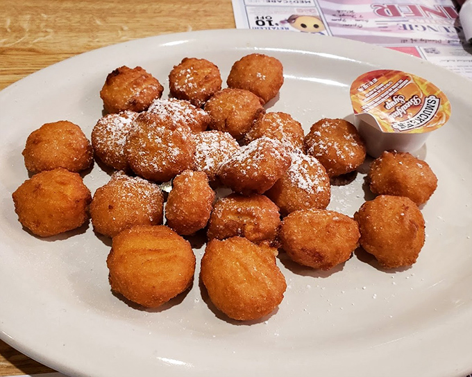 These golden-fried treasures aren't just breaded scallops &ndash; they're little orbs of joy dusted with powdered sugar, waiting to trigger childhood memories.