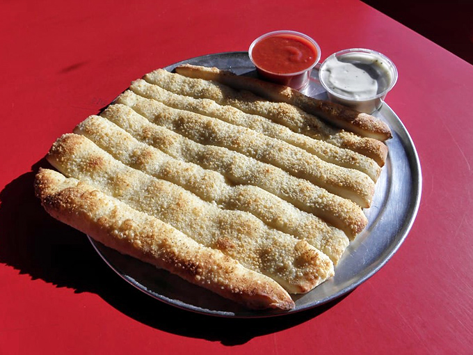 Perfectly seasoned breadsticks arrive with dipping sauces that turn a simple side into the meal's opening act superstar.
