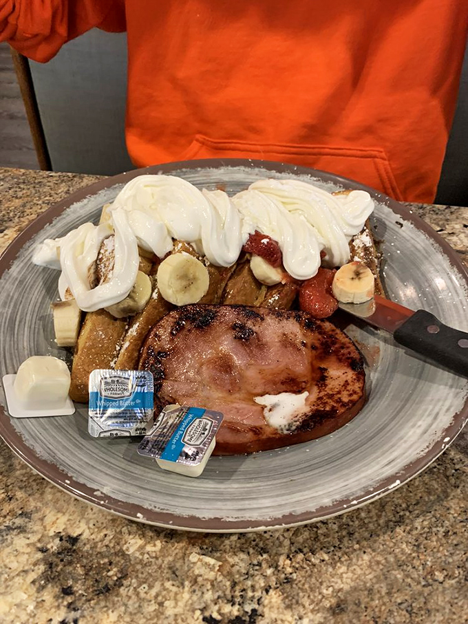 Breakfast nirvana achieved: French toast, ham, eggs, and whipped cream with fruit&mdash;the morning equivalent of hitting all green lights on your commute.