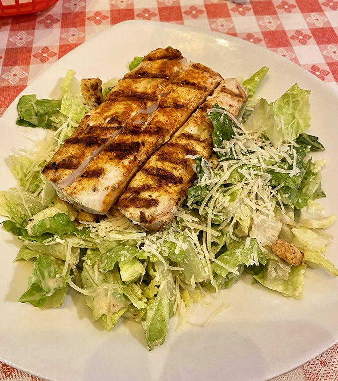 Caesar salad gets the VIP treatment with perfectly grilled fish on top. Even lettuce deserves its moment in the spotlight sometimes.