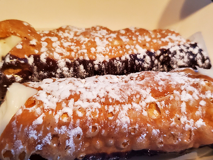 Crispy cannoli shells dusted with powdered sugar stand ready to transport your taste buds to Sicily, no passport required.