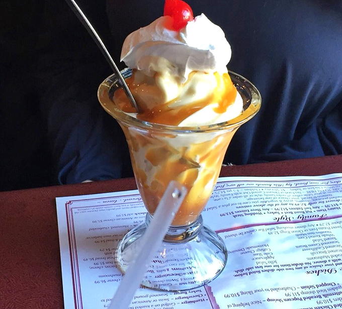 This caramel sundae towers like a sweet skyscraper, ready to topple your diet plans completely.