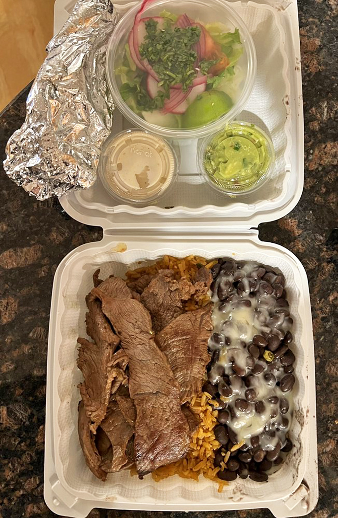 The takeout experience: where black beans glisten with cheese, fresh salsa brightens, and that foil-wrapped burrito promises comfort in every bite.
