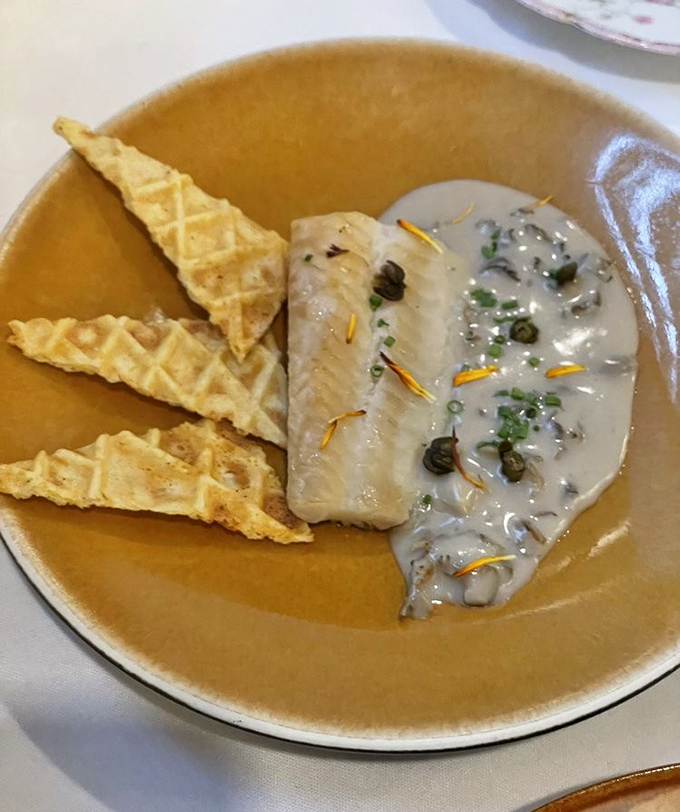 Reimagined classics: delicate white fish paired with crisp waffles &ndash; a combination that shouldn't work but absolutely sings on the palate.