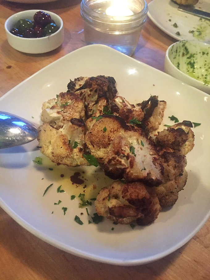 Roasted cauliflower transformed from humble vegetable to star attraction, wearing a golden tan that would make any beach-goer jealous.