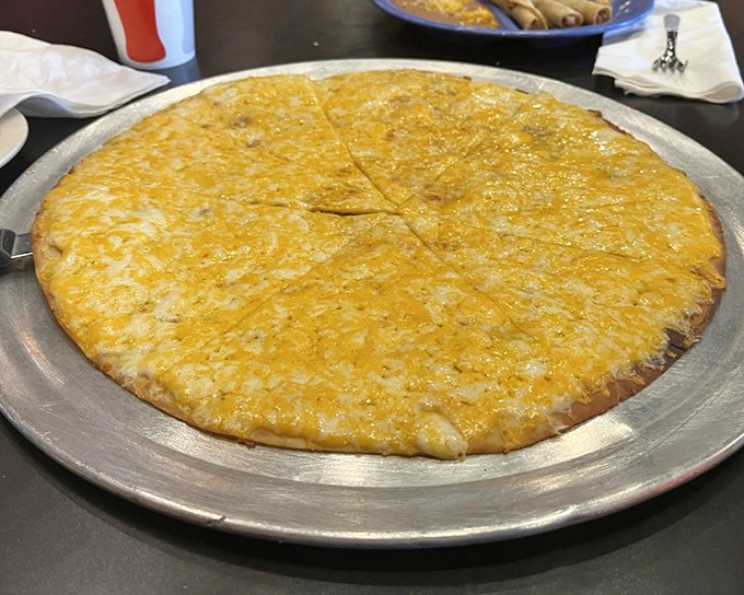 The cheese crisp arrives like a golden sun on a metal platter—Arizona's answer to pizza that deserves its own category in the comfort food hall of fame.