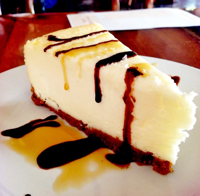 Cheesecake drizzled with chocolate and caramel—a slice of heaven that makes sharing seem like a terrible idea.