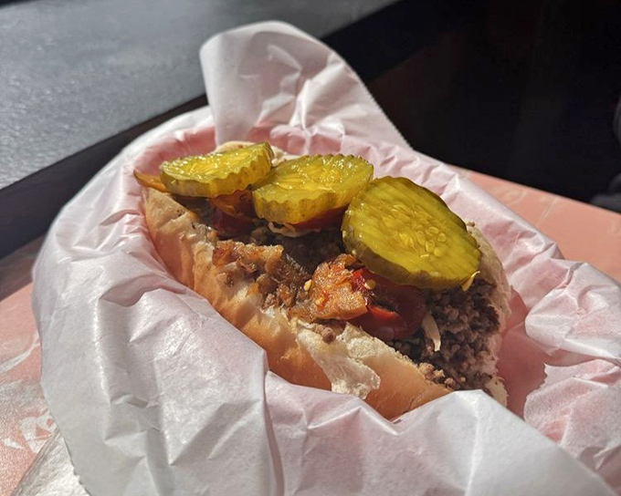 This cheesesteak isn't just food; it's a Pennsylvania tradition wrapped in paper, waiting to change your definition of sandwich perfection.