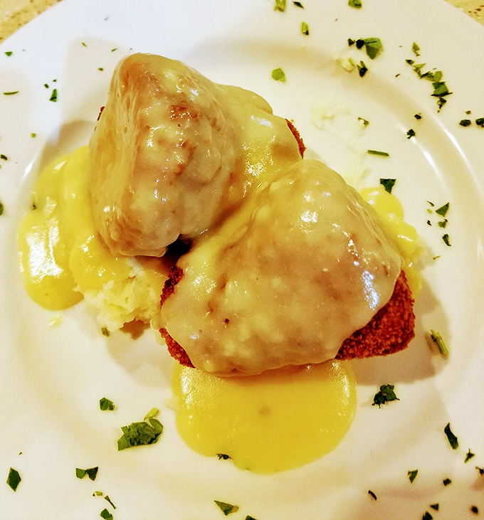 Chicken croquettes swimming in gravy&mdash;the kind of comfort food that makes you want to hug the chef and your grandmother simultaneously.