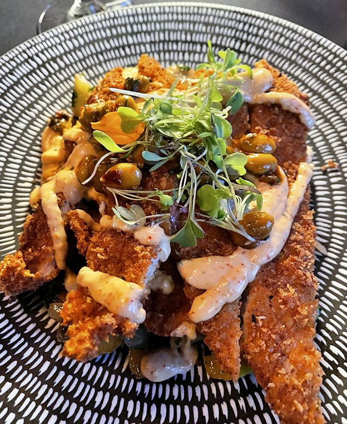 Crispy, golden-brown perfection topped with microgreens and sauce&mdash;proof that sometimes the most beautiful things in life are the crunchiest.