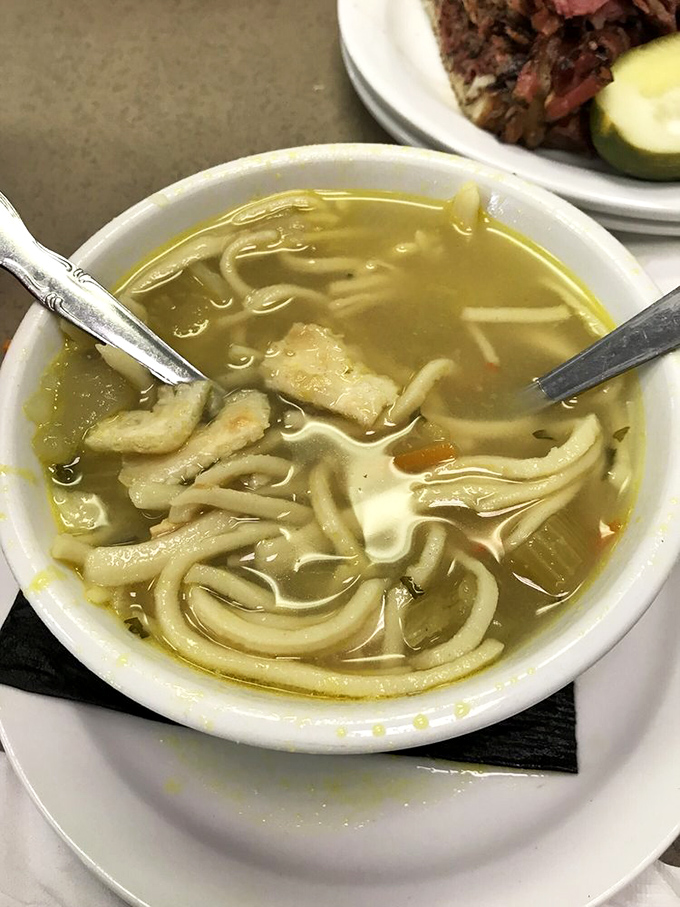 Chicken noodle soup that would make your grandmother nod in approval. Those noodles aren't just swimming—they're performing synchronized comfort.
