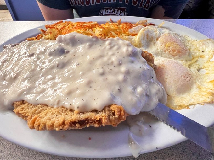 Chicken fried steak smothered in gravy with crispy hash browns&mdash;the kind of breakfast that makes you want to cancel your other meals for the day.